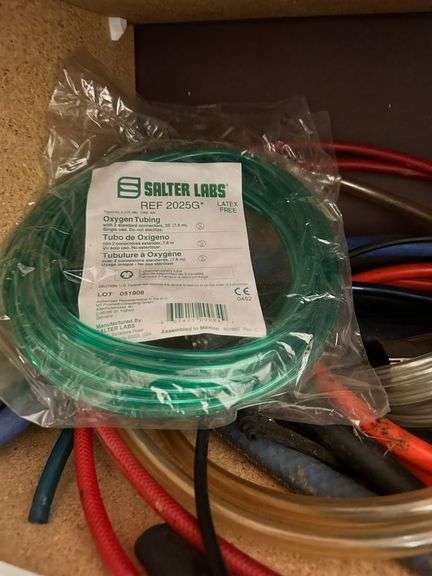 Shelf of fuel lines, oxygen tubing, and assorted rubber hose - Auction Ohio