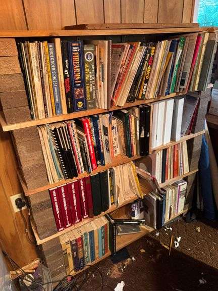Homemade Brick and Wood Bookshelf with Assorted Manuals and ...