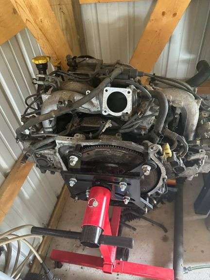 Used Subaru Boxer Engine Mounted on a Red Engine Stand - Auction Ohio