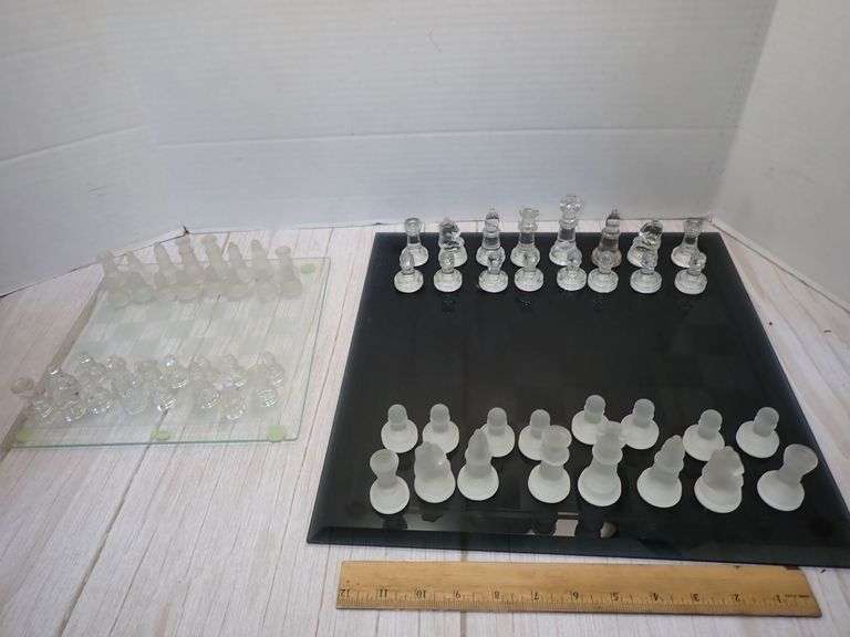 Two Glass Chess Sets with Frosted and Clear Pieces on Glass Boards ...