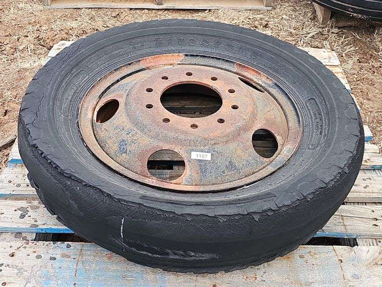 20" 10 Lug Rim With Tire - Assiter Auctioneers
