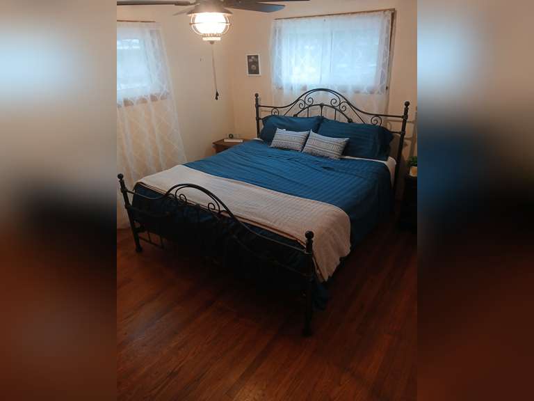 Ornate brushed metal framed king size bed featuring Sealy Posturepedic ...