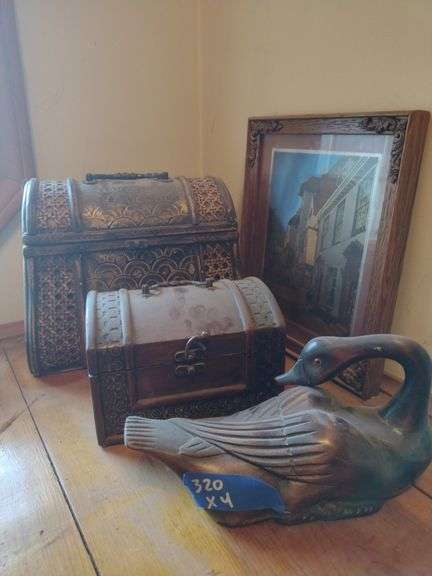 Two wooden boxes with framed art and a wooden swan on stairs ...
