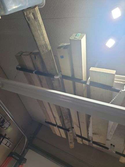 Treated 4x4 posts and other wood on garage ceiling - Advantage Auction