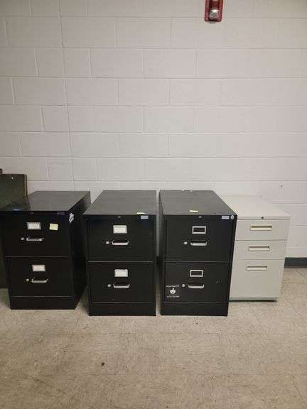 Four file cabinets three black two drawer cabinets and one beige three ...