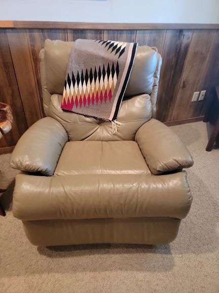 Brown rocker recliner, with small Navajo horse blanket - Advantage Auction