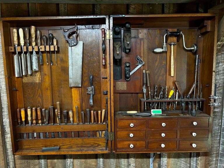 A Wall Mounted Antique Carpenter's Tool Chest with a Wide Assortment of ...