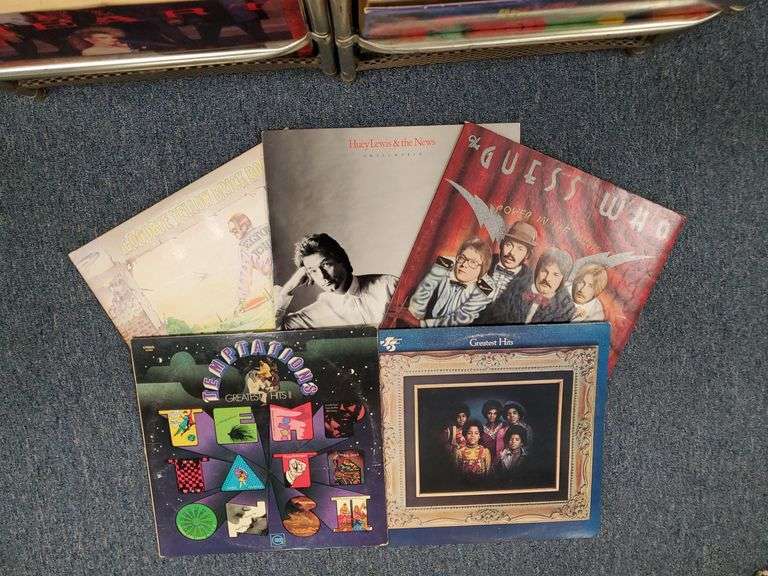 Two metal album racks with records including the rolling Stones, heart ...
