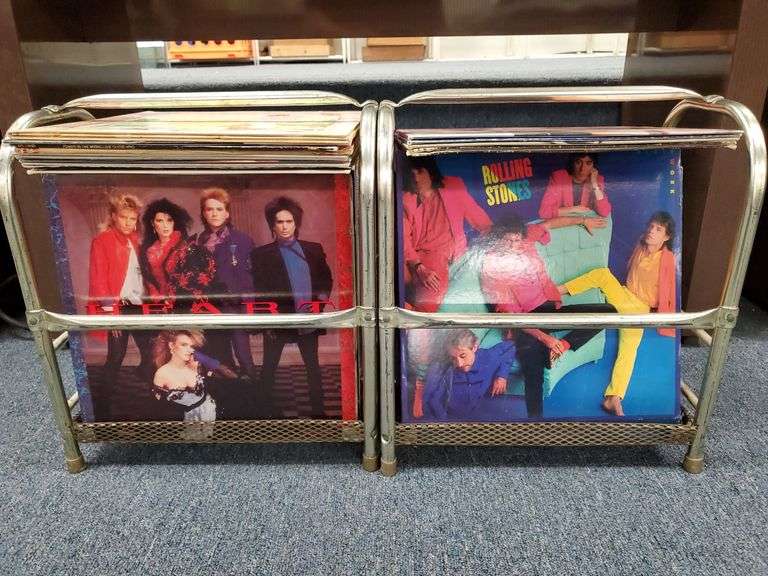 Two metal album racks with records including the rolling Stones, heart ...