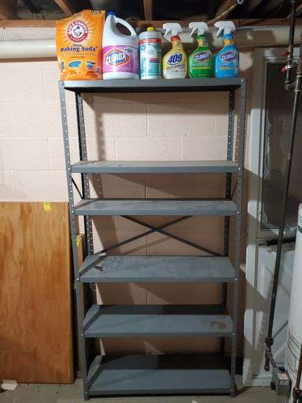 Adjustable metal shelving unit with cleaning supplies including Clorox ...