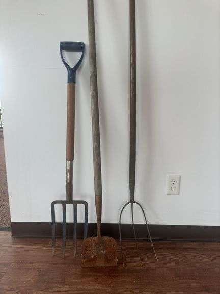 Assorted garden tools including pitch forks, pick axe, and spade - Bid ...