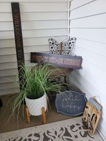 Small rattan style table with patio decor including signs, small ...