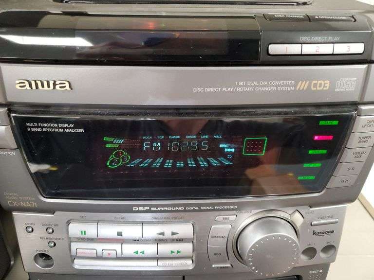 Aiwa model #CX-NA71 compact disc stereo system with remote. Features three disc CD player, two ...