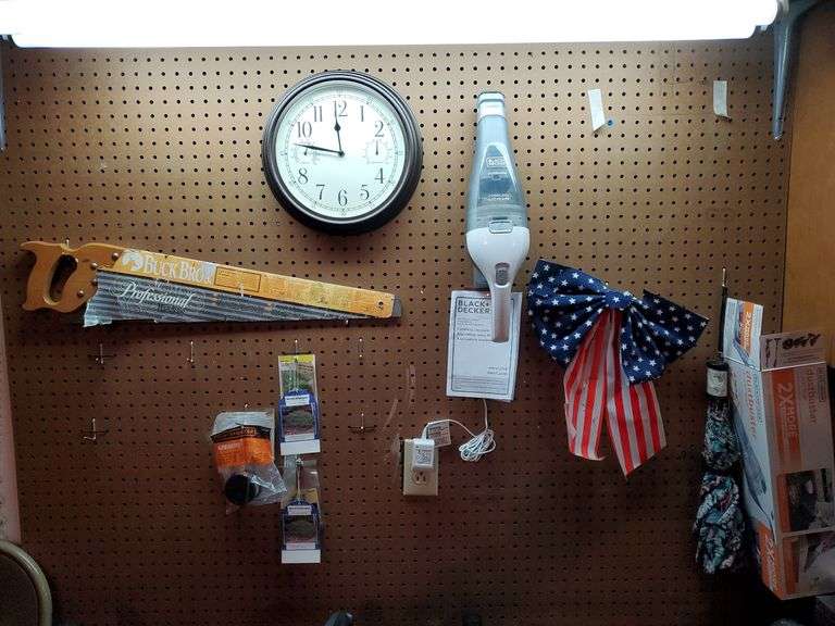 Pegboard contents including battery operated clock, Buck Brothers ...