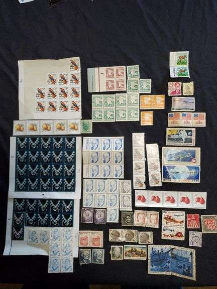 Assorted US postage stamps in denominations of $0.01, $0.02, $0.03, $0. ...