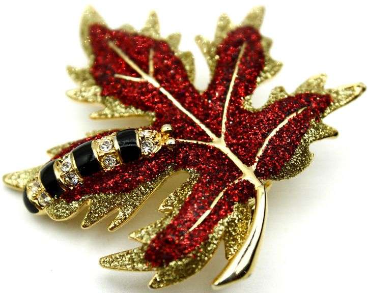 Awesome maple leaf Brooch, encrusted with crystals, hosting an encroaching caterpillar ...