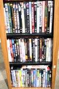Two boxes of DVDs and DVD Tower. - Bunting Online Auctions
