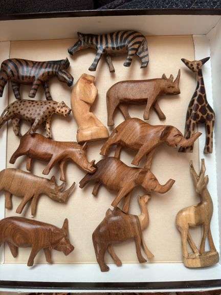 13 hand carved animals out of wood appear to be from their travels from ...