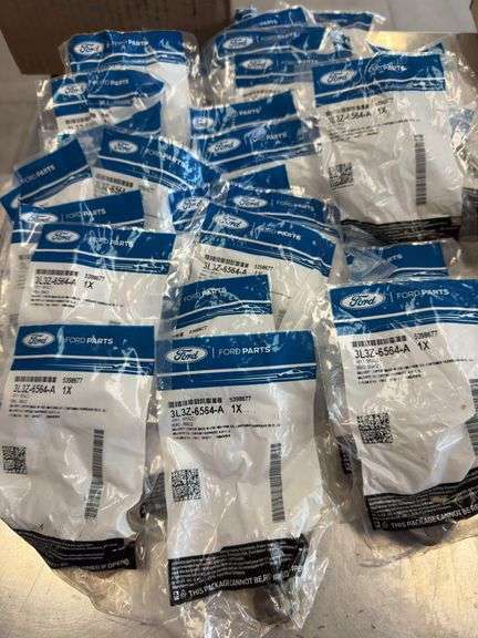 77. New Ford parts in packages, including 11 cardboard organizers for a ...