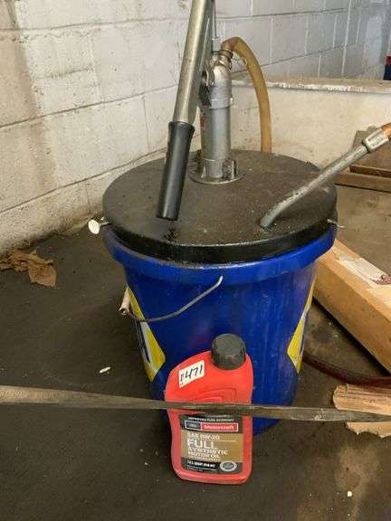 bucket with gear hand pump system and a quart of - Brian Burke Auctions