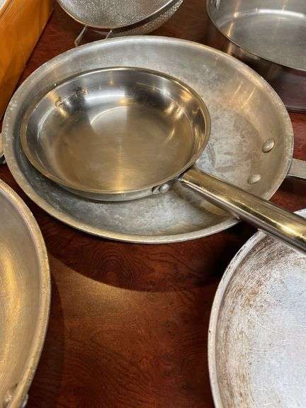 Lot of sauce pans including strainer. Two cast-iron valor, cooking pans ...
