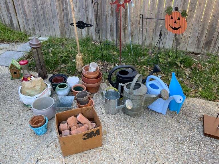 Assorted Gardening Supplies Including Pots, Watering Cans, and Decorative Yard Stakes - Coastal ...