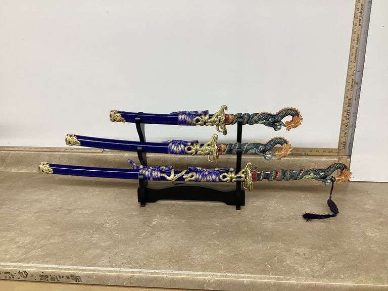 3 DRAGON HANDLED SWORDS ON STAND - Currie Auction Service