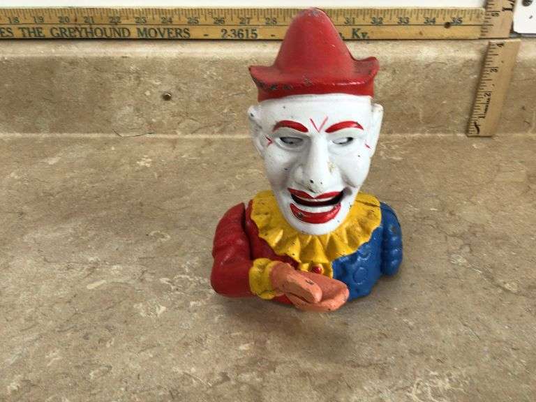 VINTAGE CAST IRON MECHANICAL CLOWN BANK - Currie Auction Service
