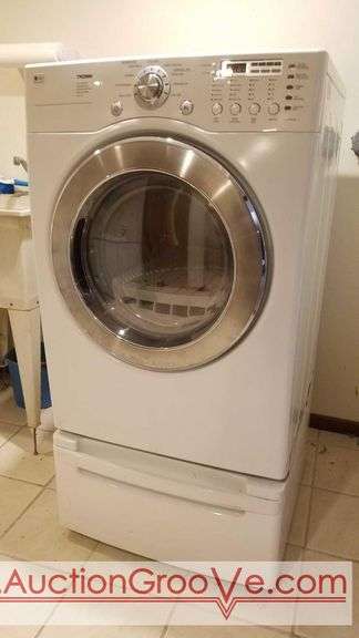 Tromm Electric Dryer, model DLE5977W by LG. Includes a pedestal with ...