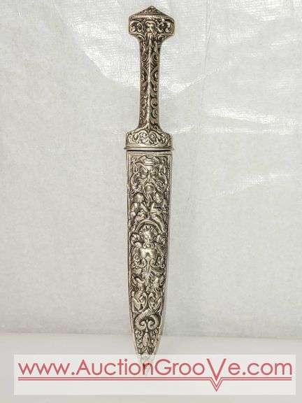 Elaborately chased Dagger. Features Cherubs, Dragons and Evil looking ...