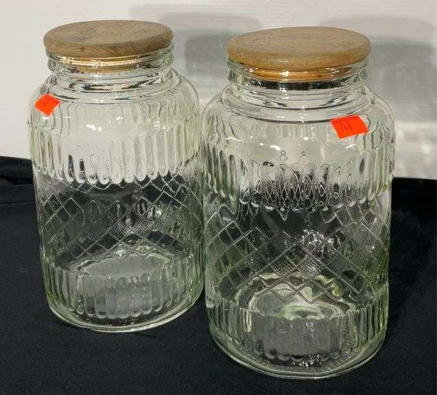 Two clear glass canisters with textural details, 13in tall - Hash Auctions