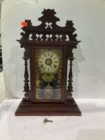 Ornate clock with key. - Hash Auctions