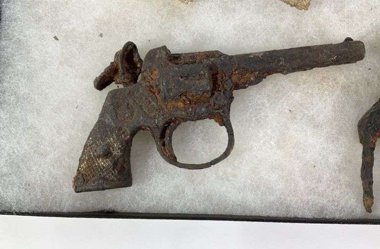 Rusty gun relics in case. - Hash Auctions