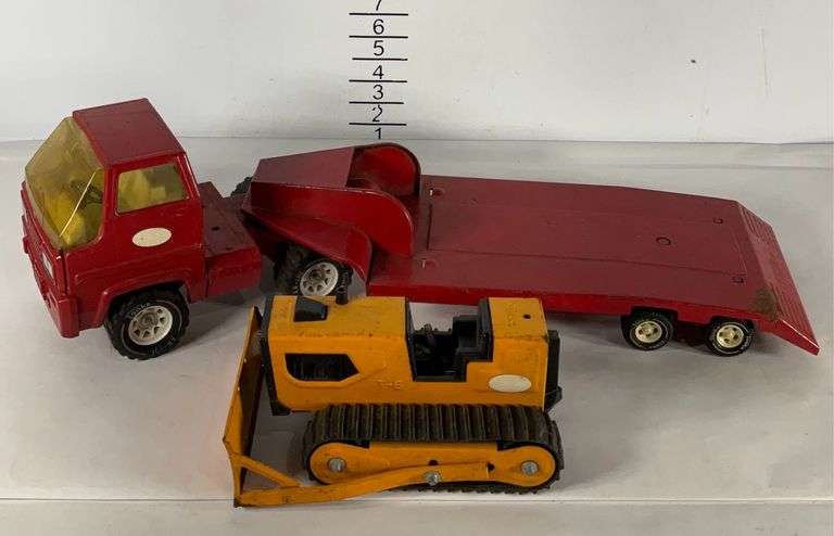 Metal Tonka bulldozer and flat bed trailer with cab. - Hash Auctions