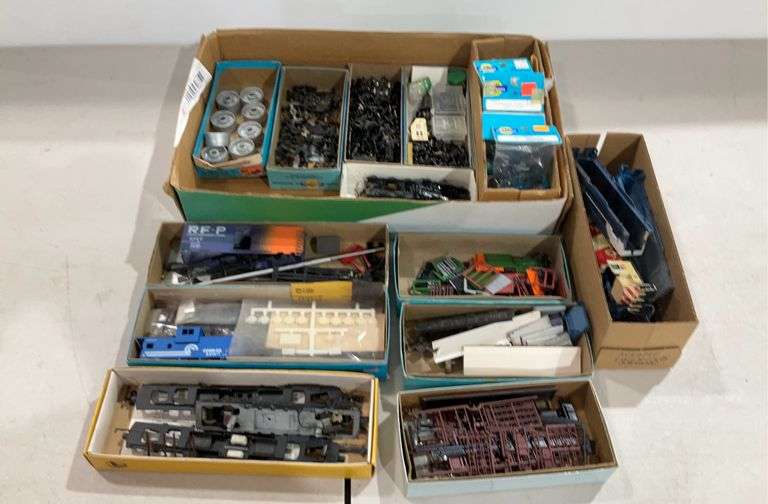 Train parts and pieces. Includes train wheels, shells of cars, power ...