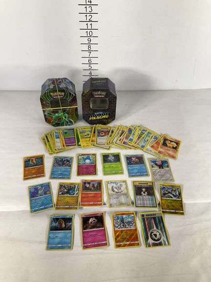 Two Pokemon tins with Pokemon cards. Some common Holo. - Hash Auctions