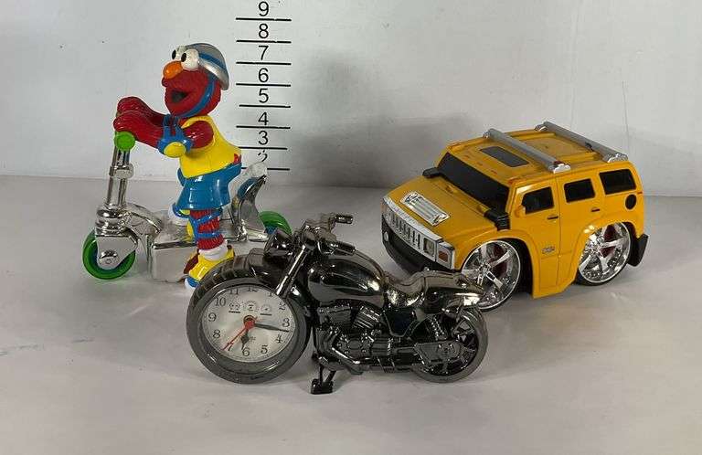 Hummer play car, Elmo on a scooter toy, and a battery operated ...