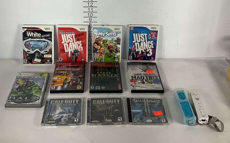 Two Wii controllers, four Wii games, three PS2 games, Xbox game and a ...