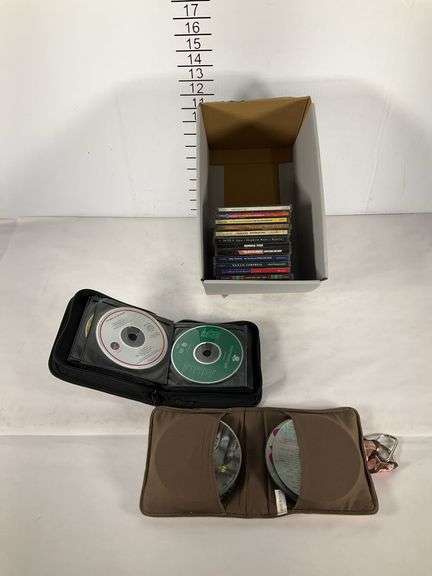 Two cd cases with cds and more cds. - Hash Auctions