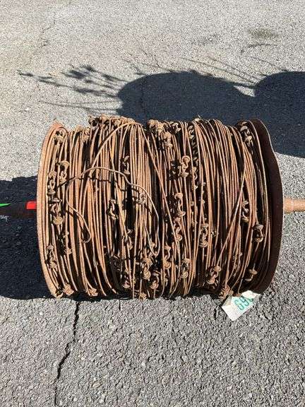 Large Roll of Vintage Rusted Barbed Wire on Metal Spool - Hash Auctions