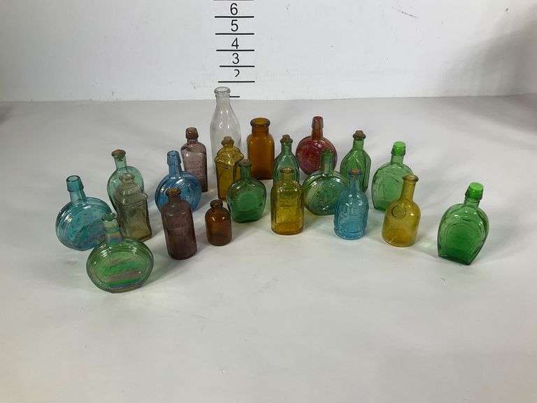 Collection of Colored Glass Bottles, Including Embossed and Iridescent ...