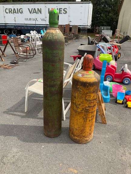 Two Metal Gas Cylinders, Green and Yellow, With Potential Contents ...