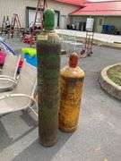 Two Metal Gas Cylinders, Green and Yellow, With Potential Contents ...