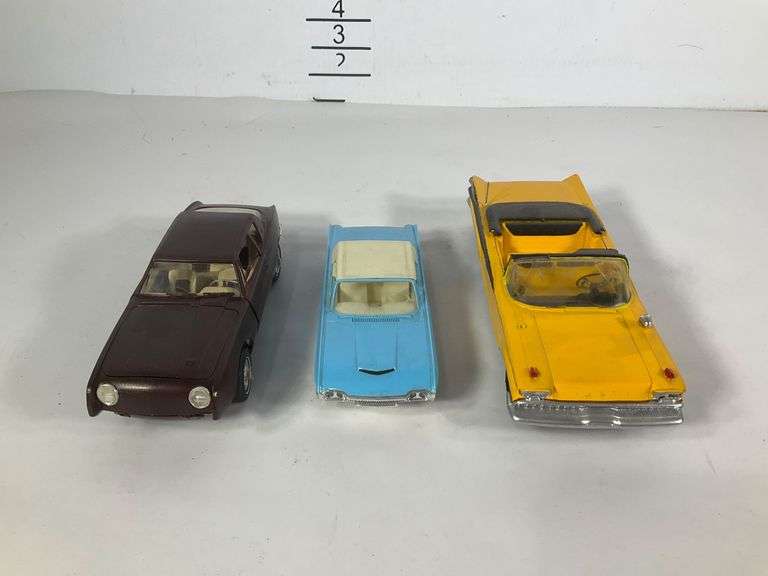Set of Three Plastic Model Cars in Brown, Blue, and Yellow Finishes ...