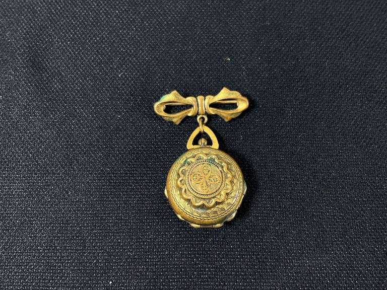 Gold-Tone Locket with Bow Pin and Triple Hinged Interior Photo ...