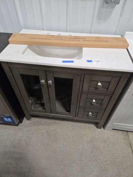 Vanity with sink. Counter top is cracked. Glass in doors broke. No ...