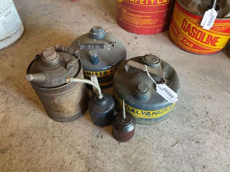 Three metal fuel cans, two oil cans - Hurley Real Estate & Auctions
