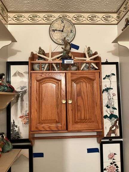 Content of Wall cabinet: mud men figurines, starfish, wall clock ...