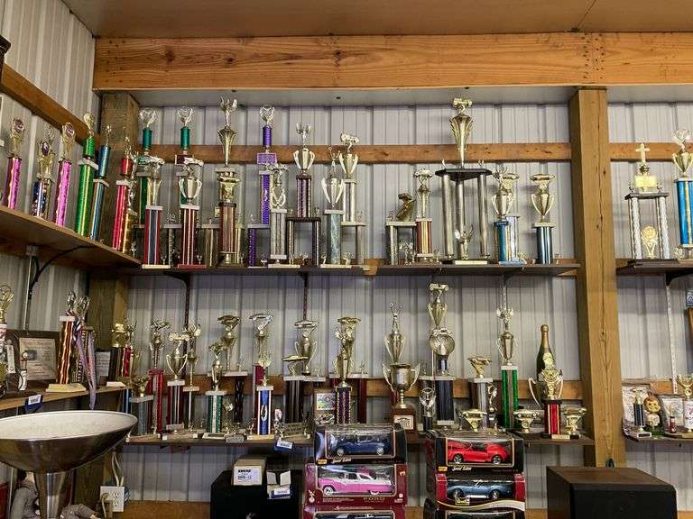Contents of two shelves: car show trophies - Hurley Real Estate & Auctions