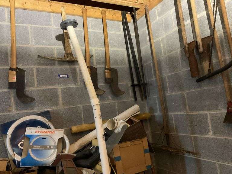 Brush axes, pick, bar clamps hanging on wall - Hurley Real Estate ...